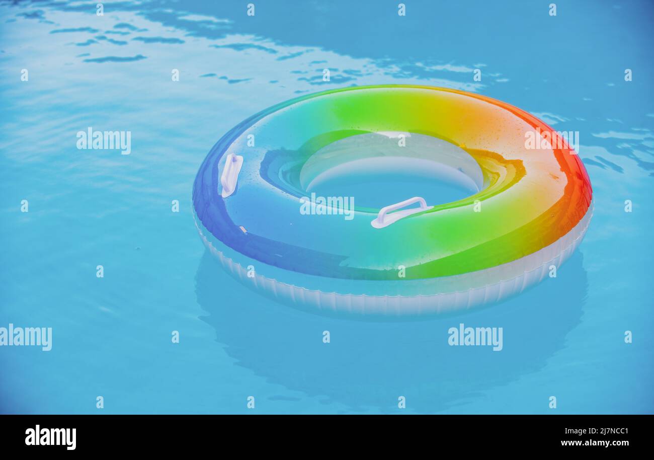 Inflatable ring floating in blue swimming pool. Summer background Stock ...