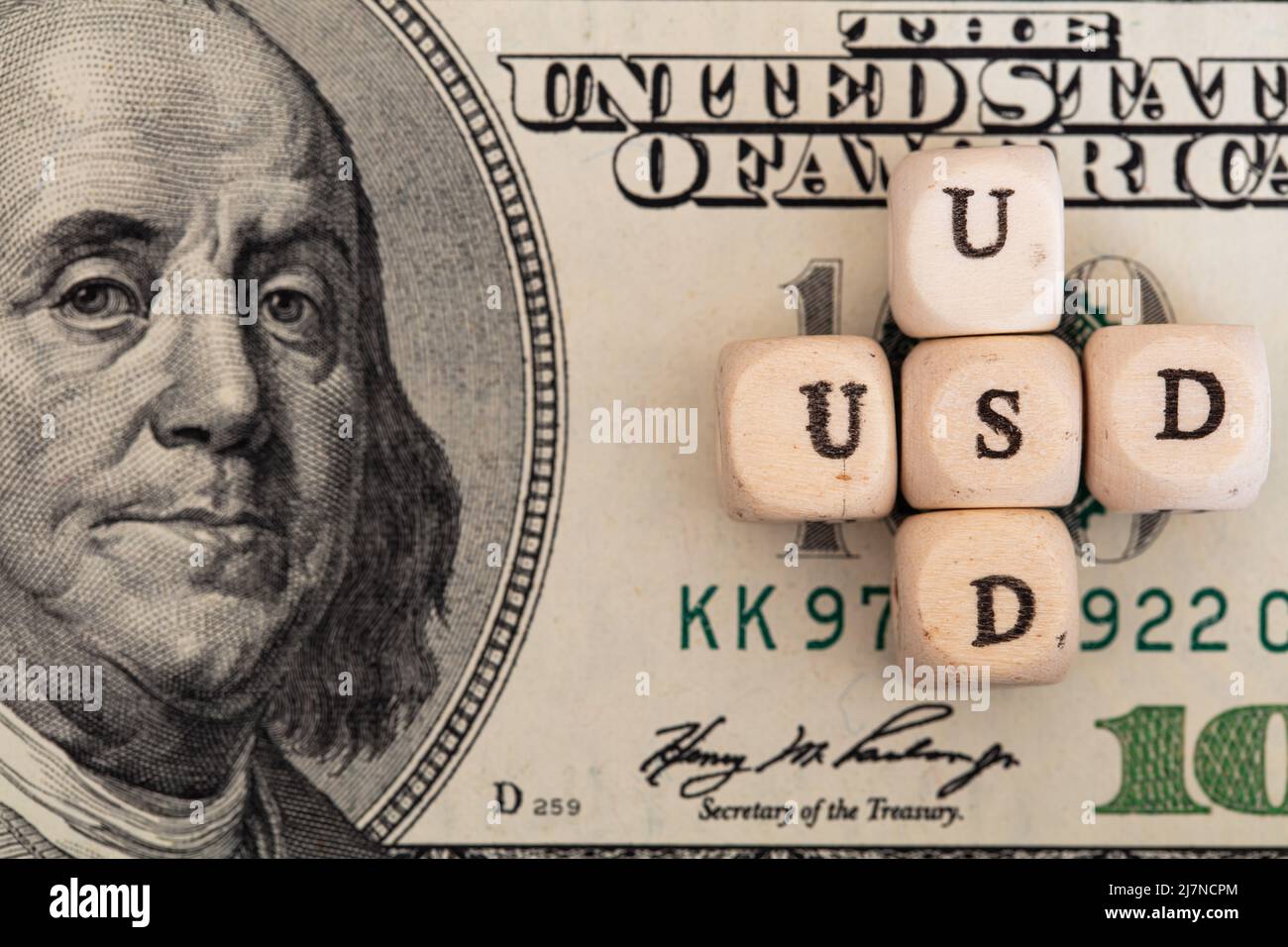 USD word written on wooden blocks on 100 dollar banknote background for ...