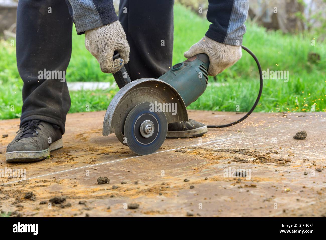 Construction worker sawing with saw disk cutter the metal Stock Photo ...