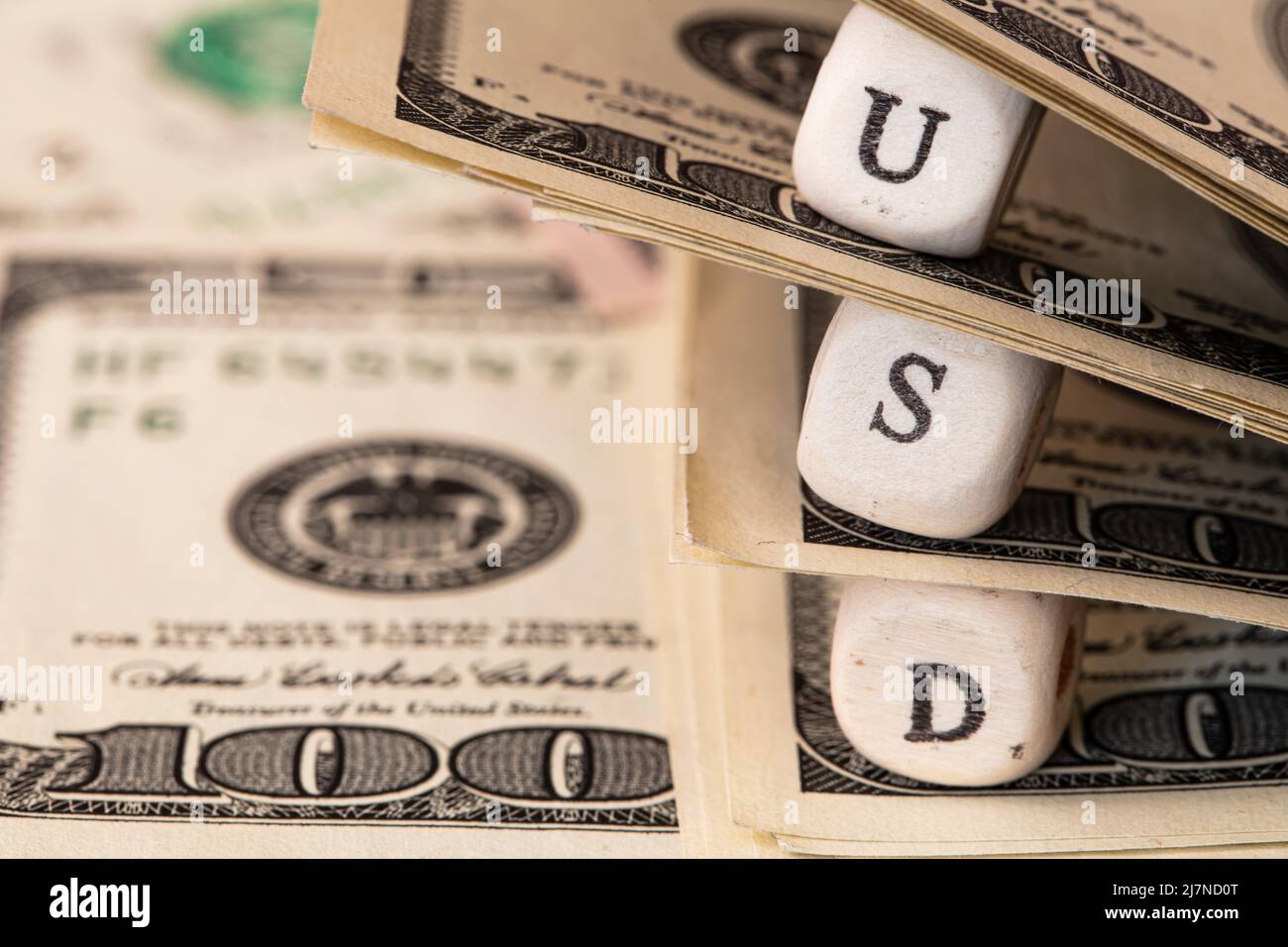 USD word written on wooden blocks on 100 dollar banknote background for ...