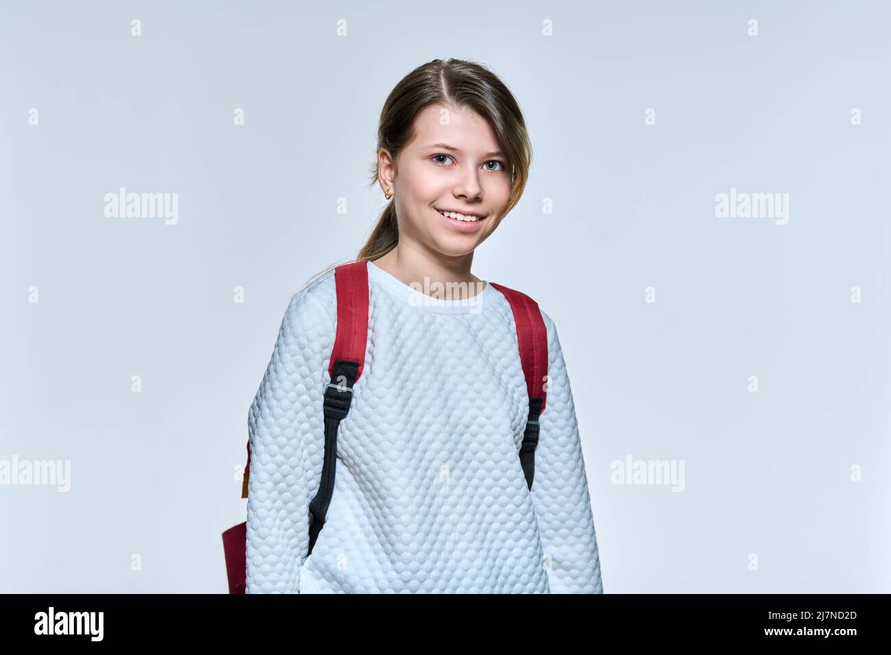 Portrait of schoolgirl 11, 12 years old with backpack, girl looking at ...