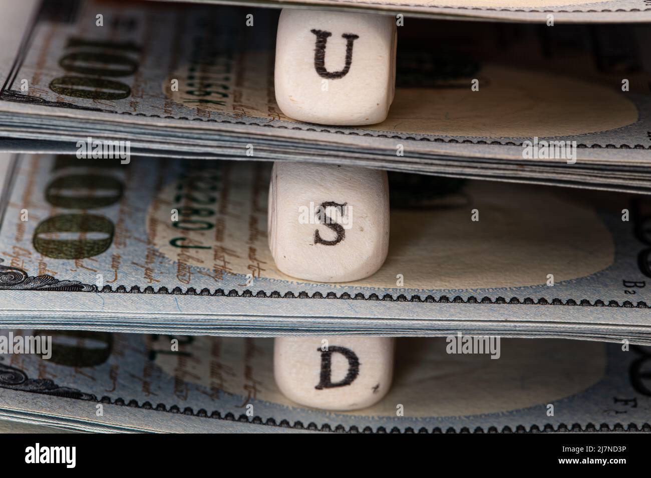 USD word written on wooden blocks on 100 dollar banknote background for ...
