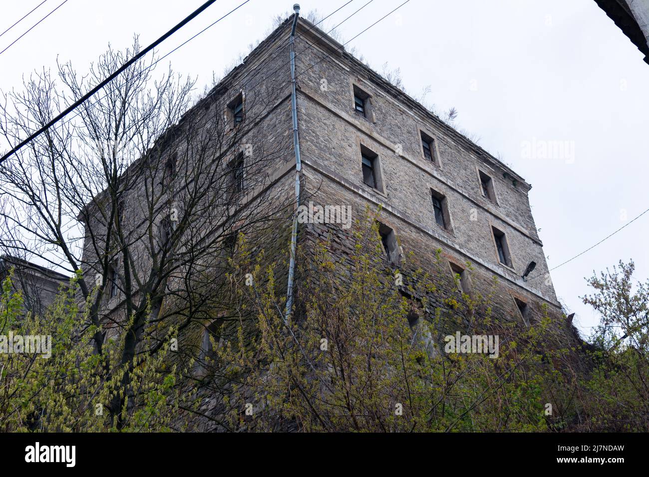An old abandoned stone building is collapsing in the open air. A ...