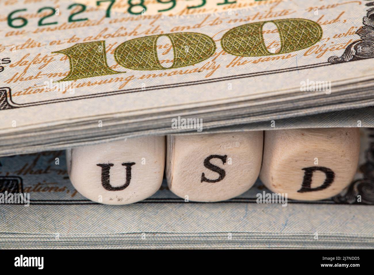 USD word written on wooden blocks on 100 dollar banknote background for ...