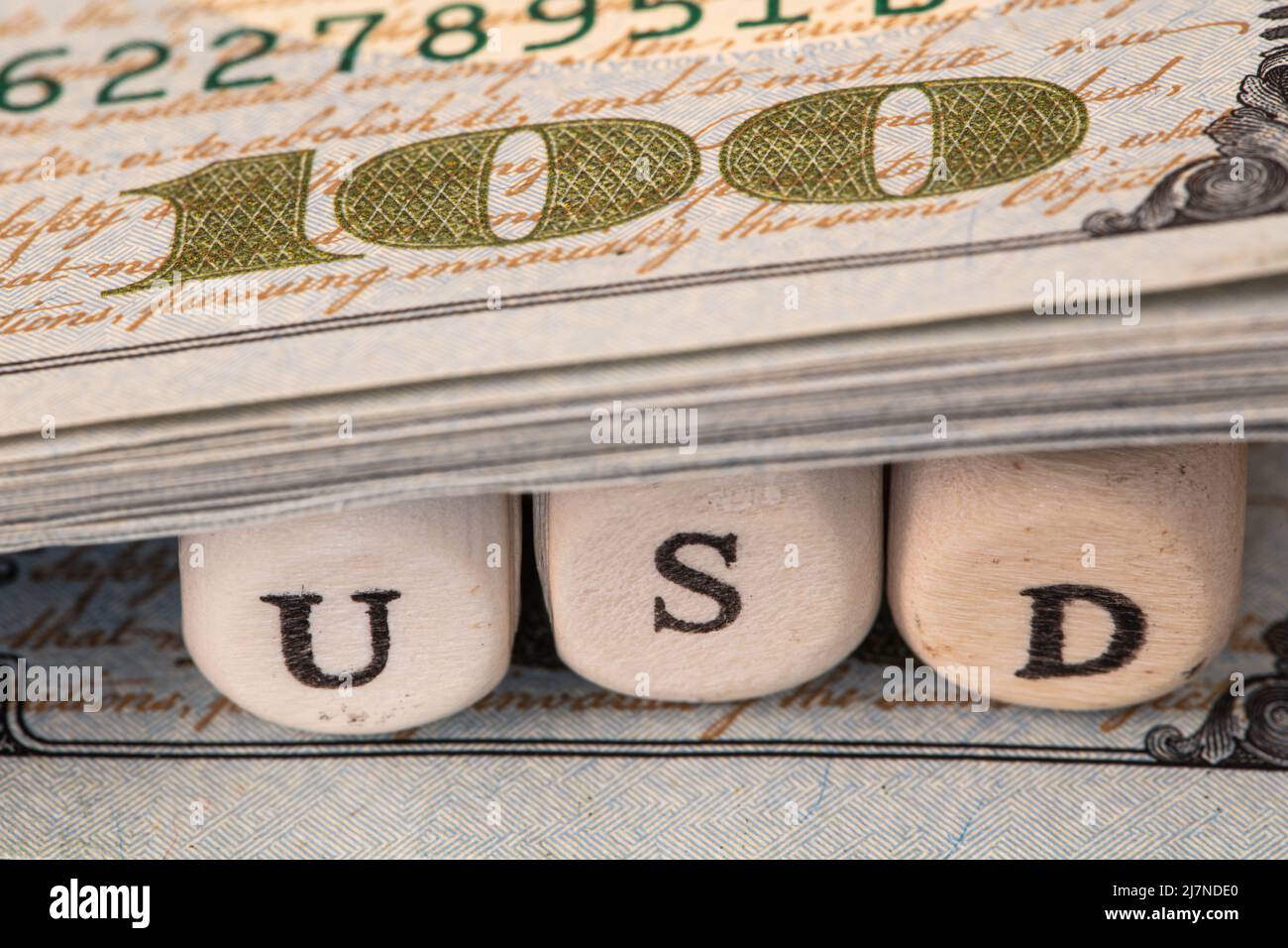 USD word written on wooden blocks on 100 dollar banknote background for ...