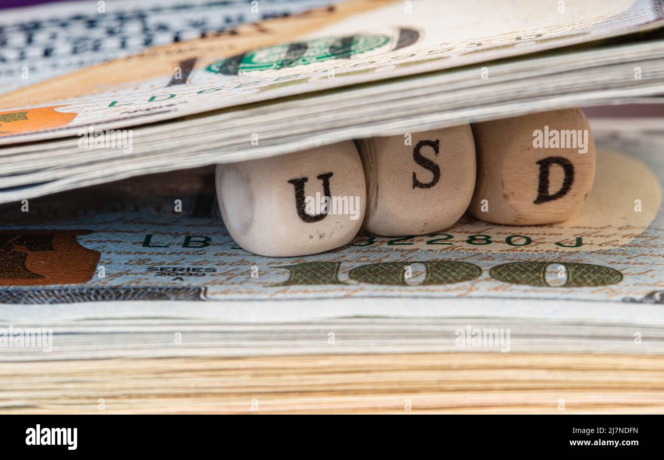 USD word written on wooden blocks on 100 dollar banknote background for ...