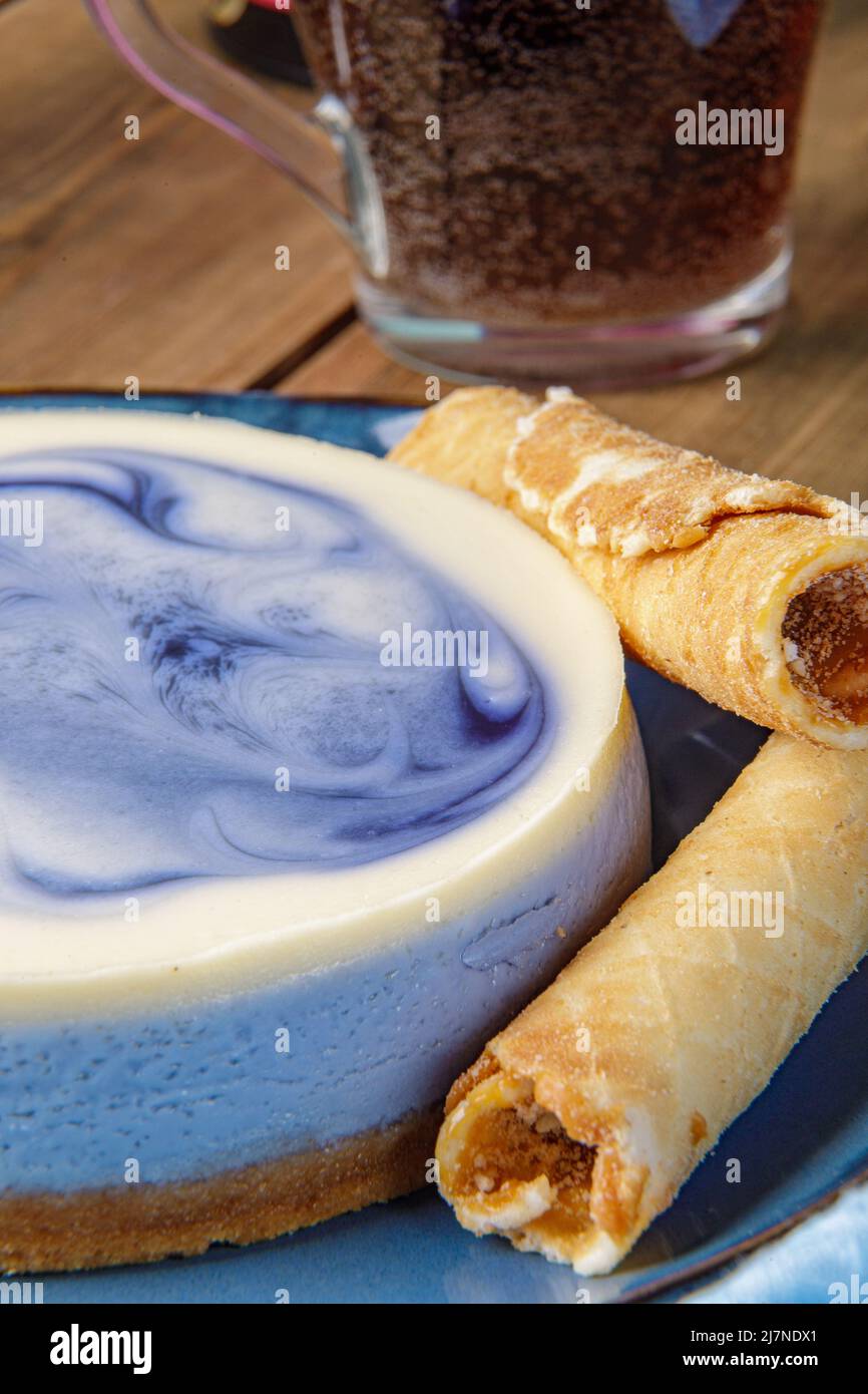 Cheesecake with blueberries and confectionery tubes with condensed milk ...