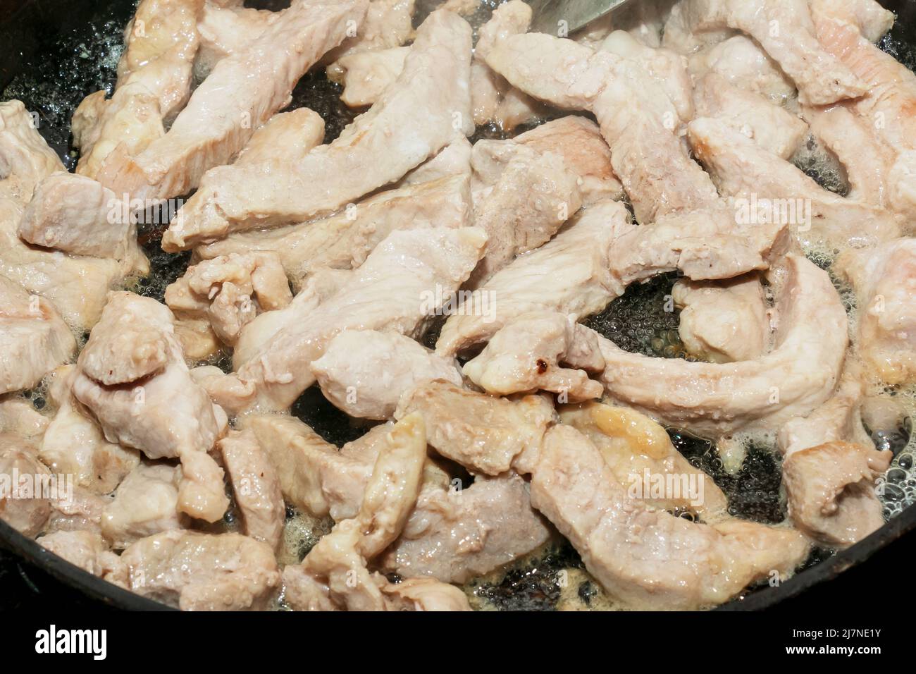 Close-up of fried pork pieces in the process of frying Stock Photo - Alamy