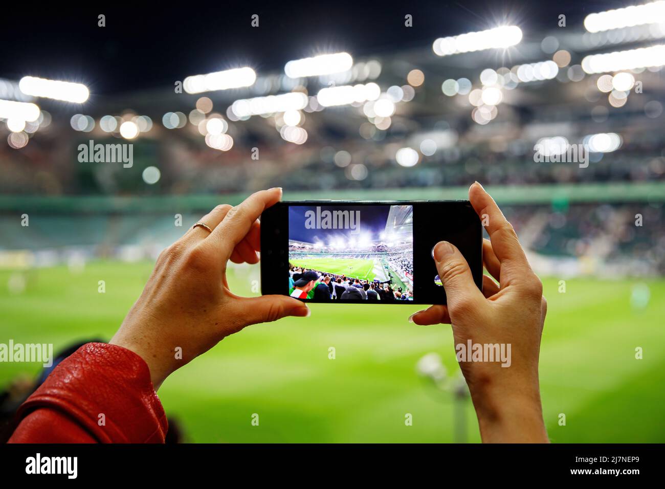 Fan hand with smartphone photographing football match. Using mobile ...