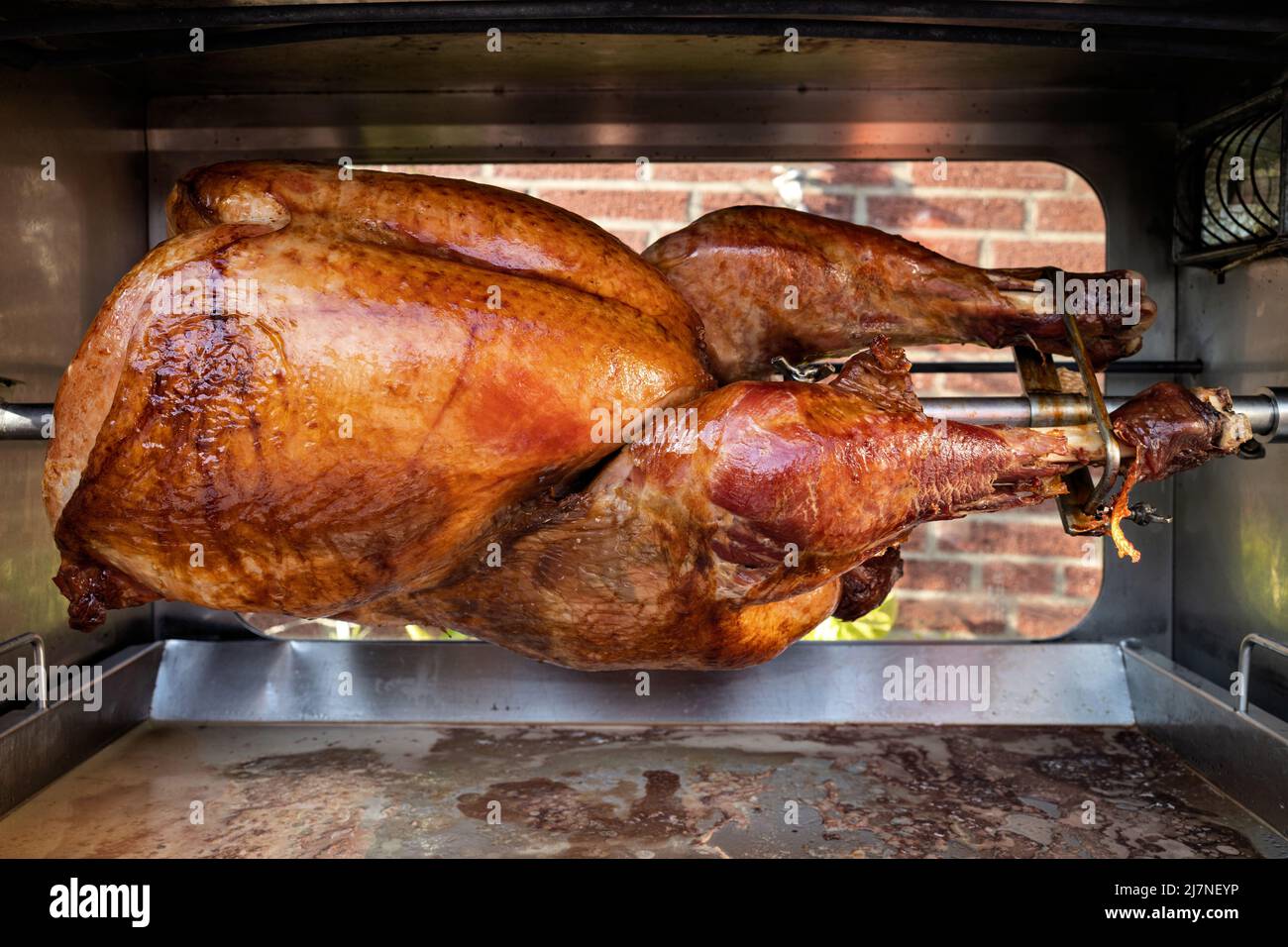 crispy rotisserie turkey in outdoor cooker Stock Photo - Alamy