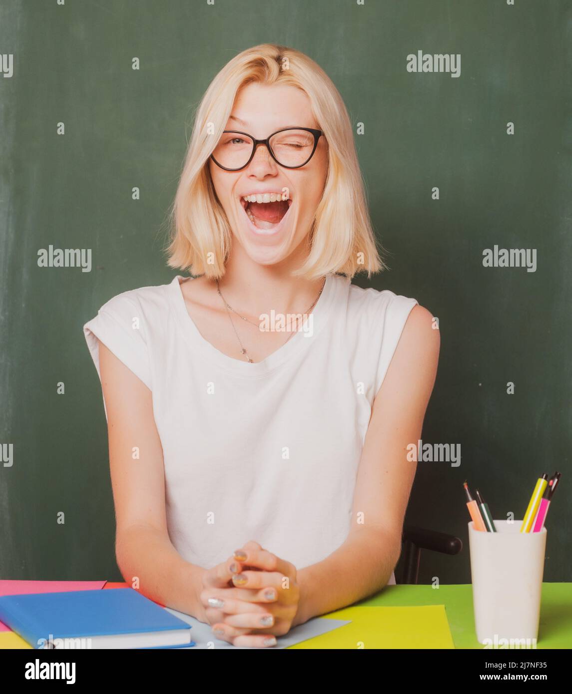 Happy funny teacher winking. Portrait of young caucasian female teacher ...