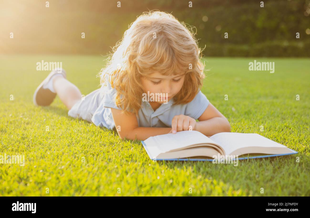 Smart clever Kids. Cute lovely child reading book outside. Kid read ...