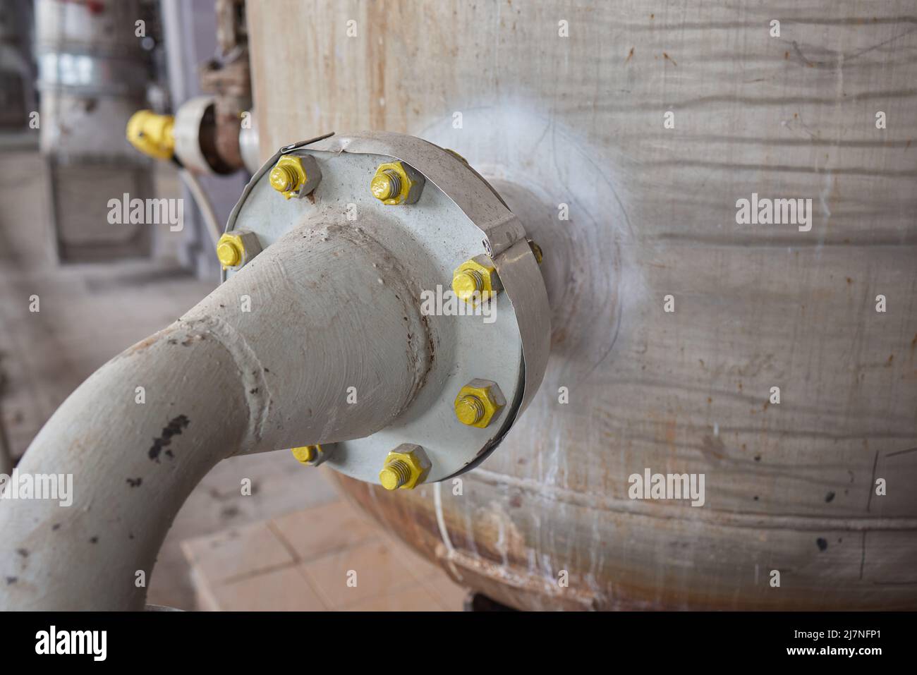 Close-up at pipeline valve which is using to control production process ...