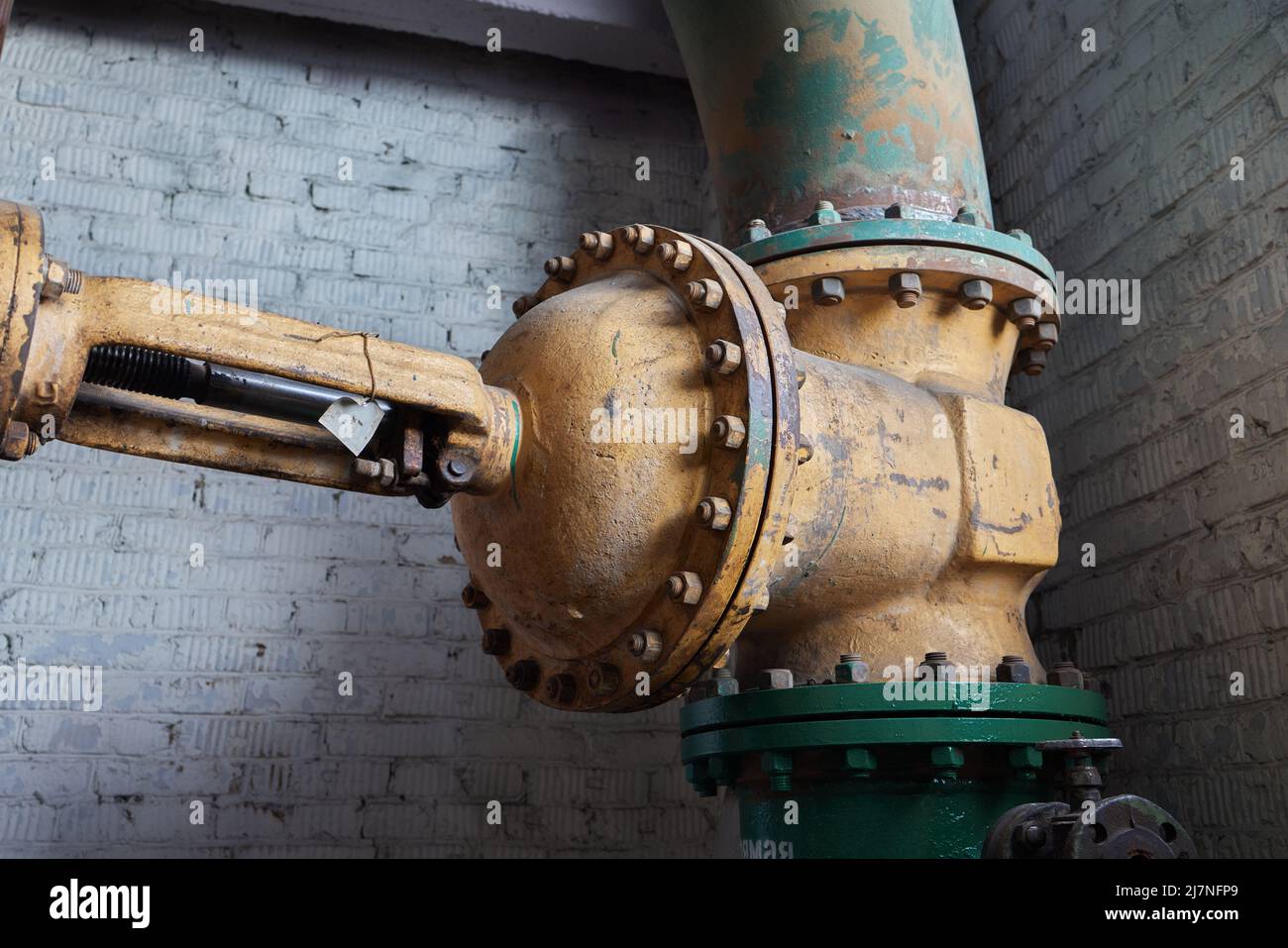 Close-up at pipeline valve which is using to control production process ...