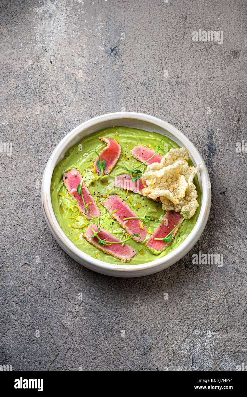 Restaurant dish: fresh tuna tartar on avocado puree op view Stock Photo ...