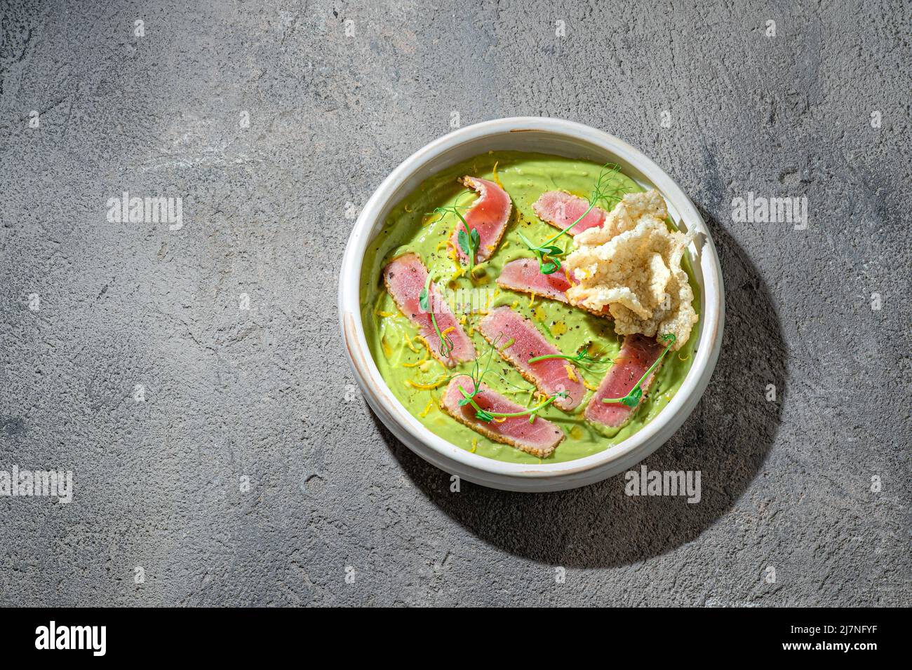 Restaurant dish: fresh tuna tartar on avocado puree op view Stock Photo ...