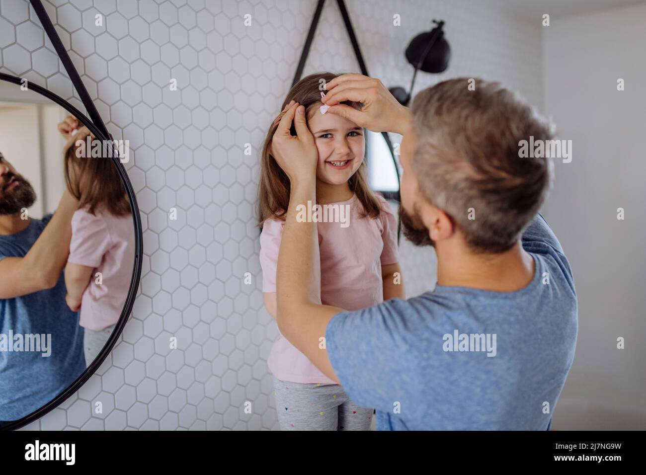 Father brushing his little daughter's hair in bathroom, morning routine concept Stock Photo - Alamy