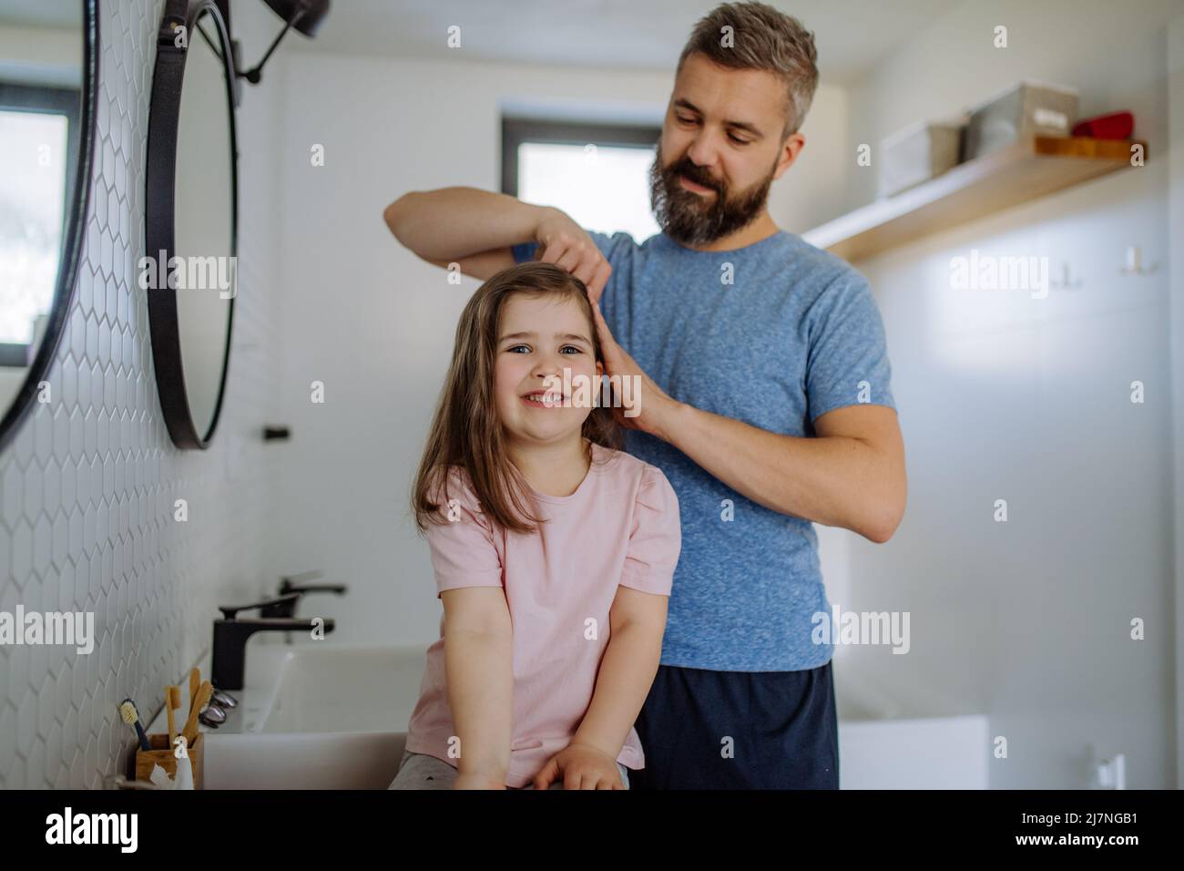 Father brushing his little daughter's hair in bathroom, morning routine concept Stock Photo - Alamy