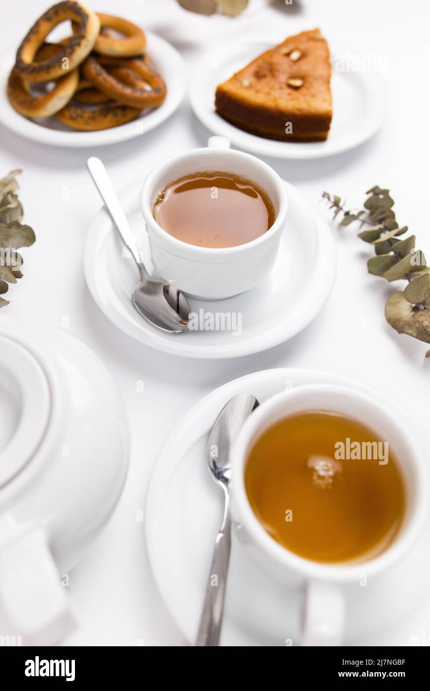 a white tea set with teapot tea and saucers and pie for breakfast Stock ...