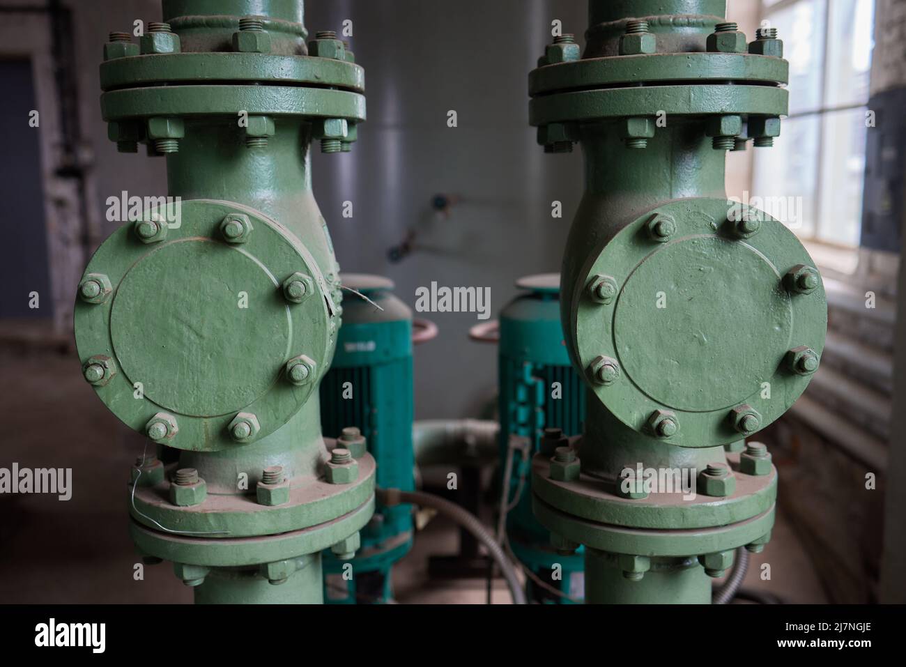 Close-up at pipeline valve which is using to control production process ...