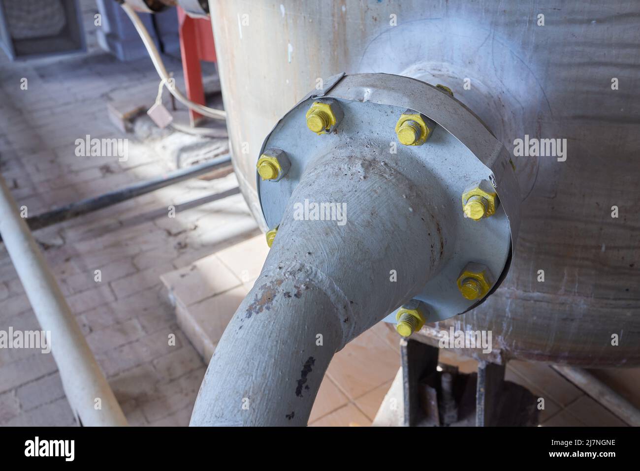 Close-up at pipeline valve which is using to control production process ...