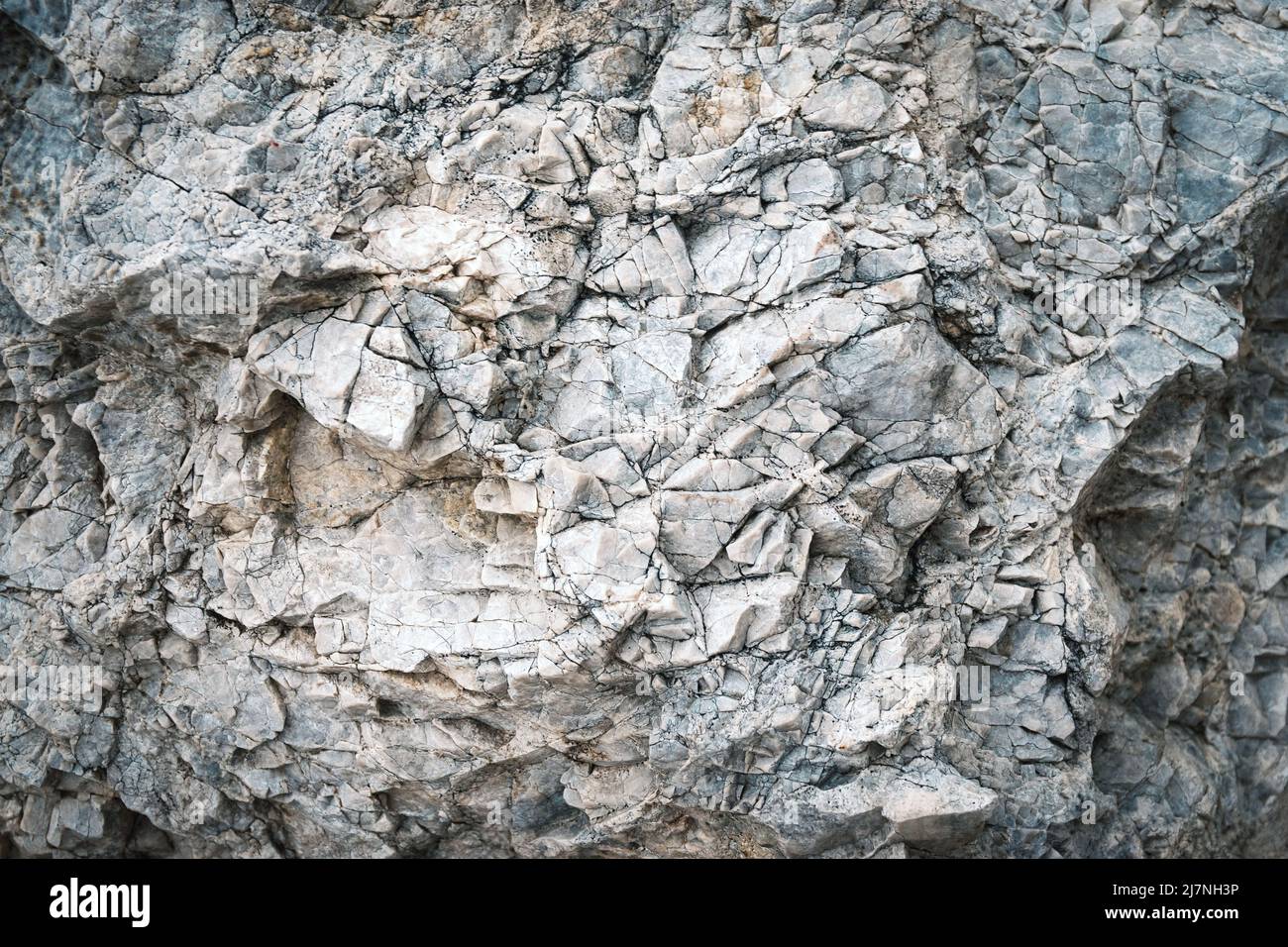 background or texture cracks on a block of gray white limestone Stock ...