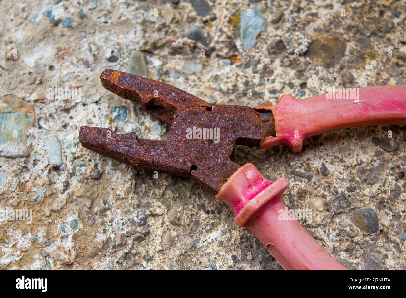 Old rusty pliers. Closeup photo of aged red pliers Stock Photo - Alamy