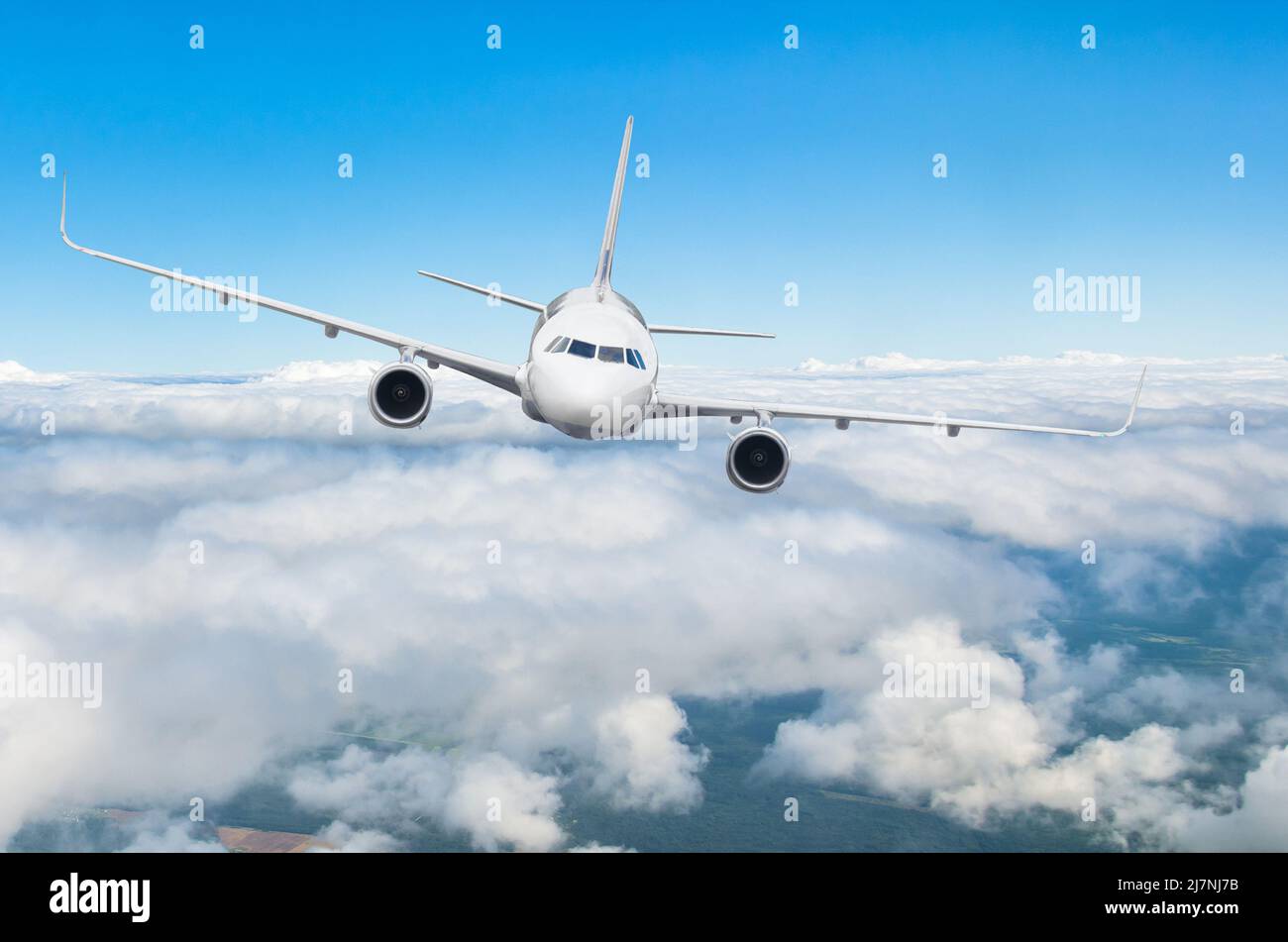 Airplane jet flying at flight level high in the sky above the clouds ...