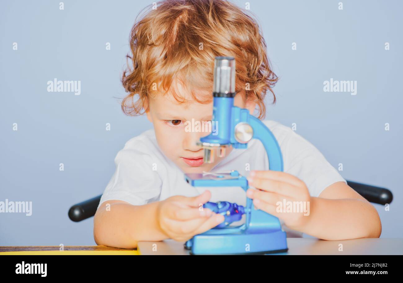 Cute child toddler boy play with microscope. Concept of education and ...