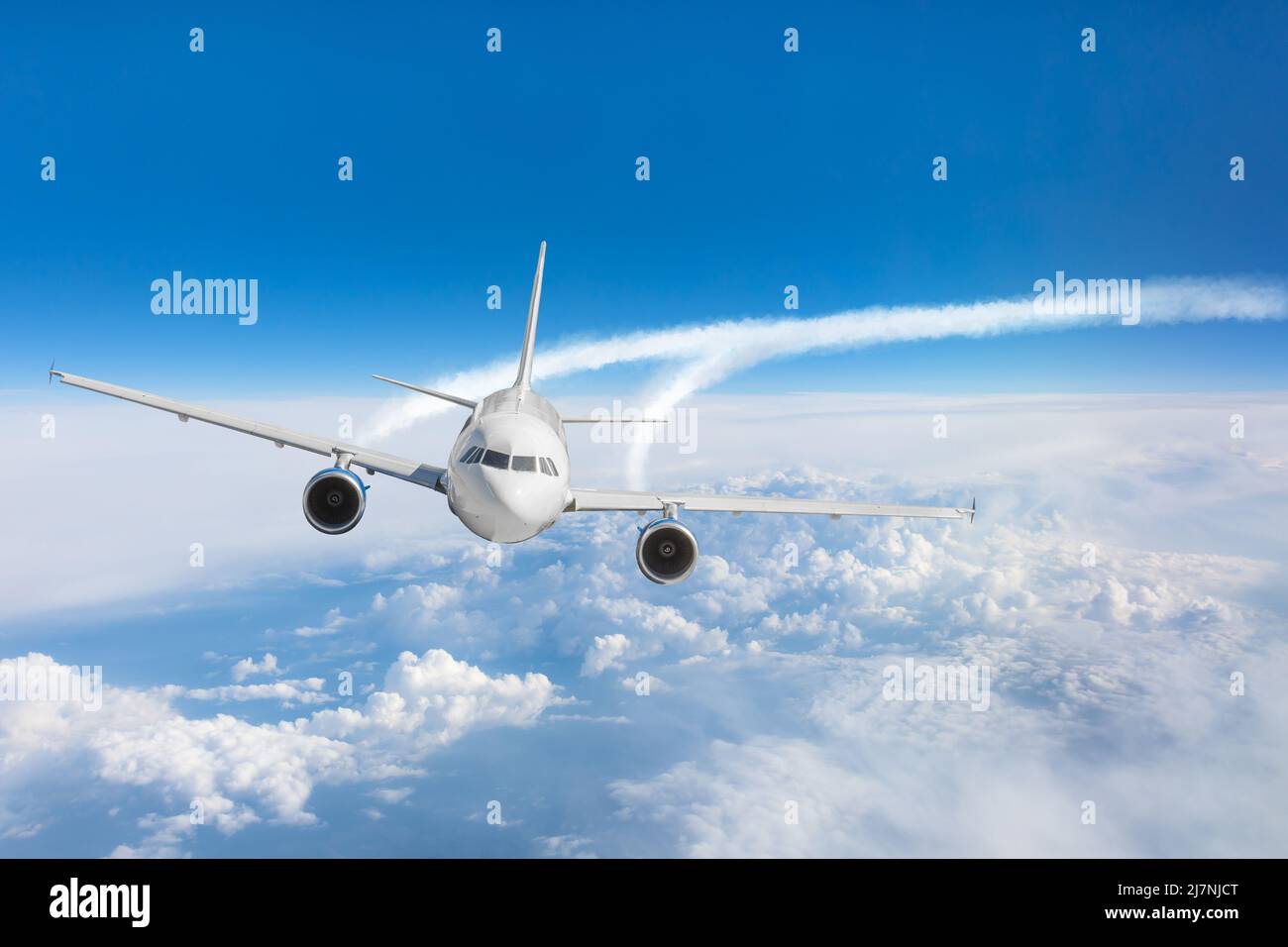 Passenger airplane flying at flight level high in the sky above the ...