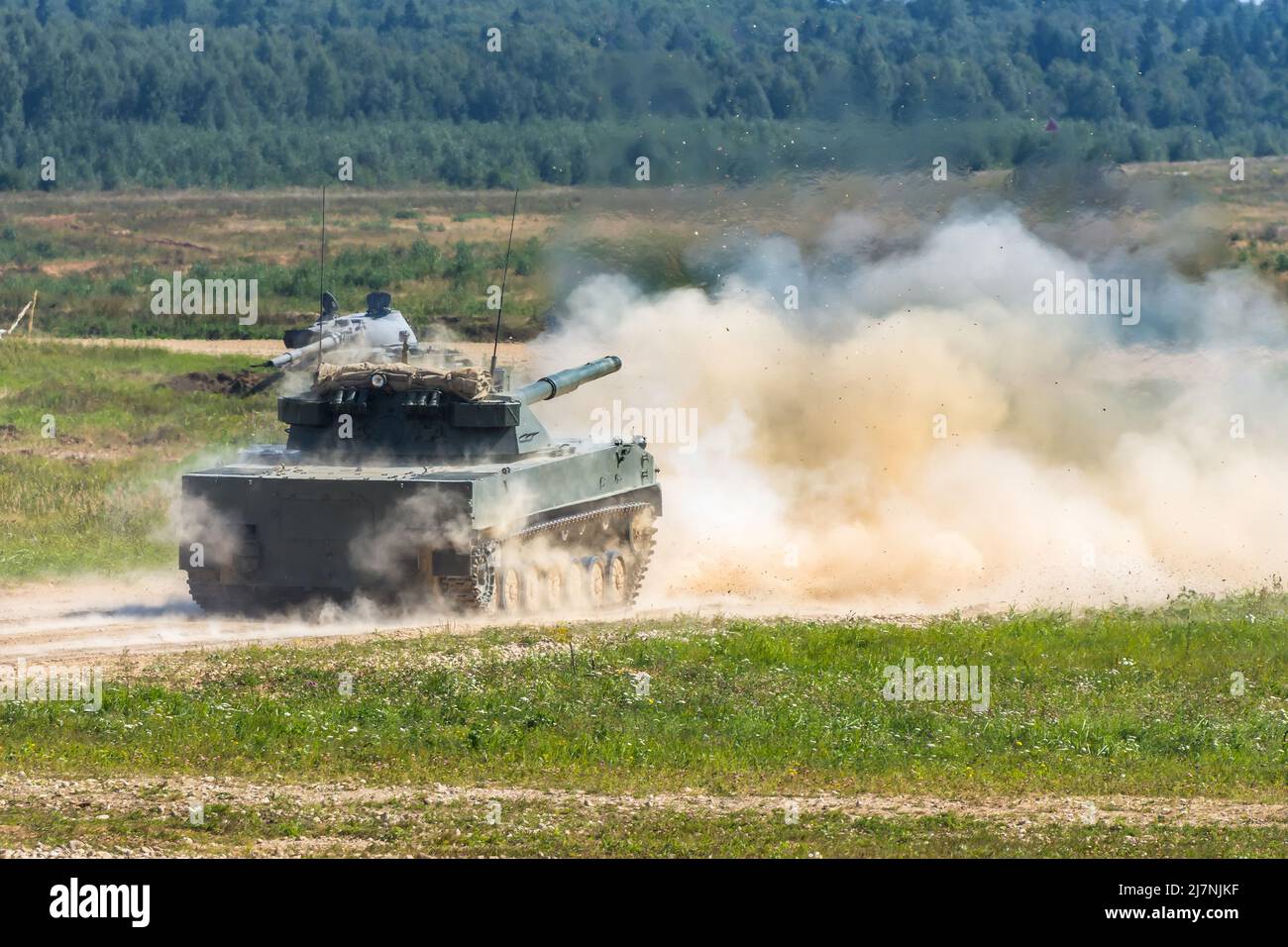The military tank makes a shot at the enemy targets in the field Stock ...