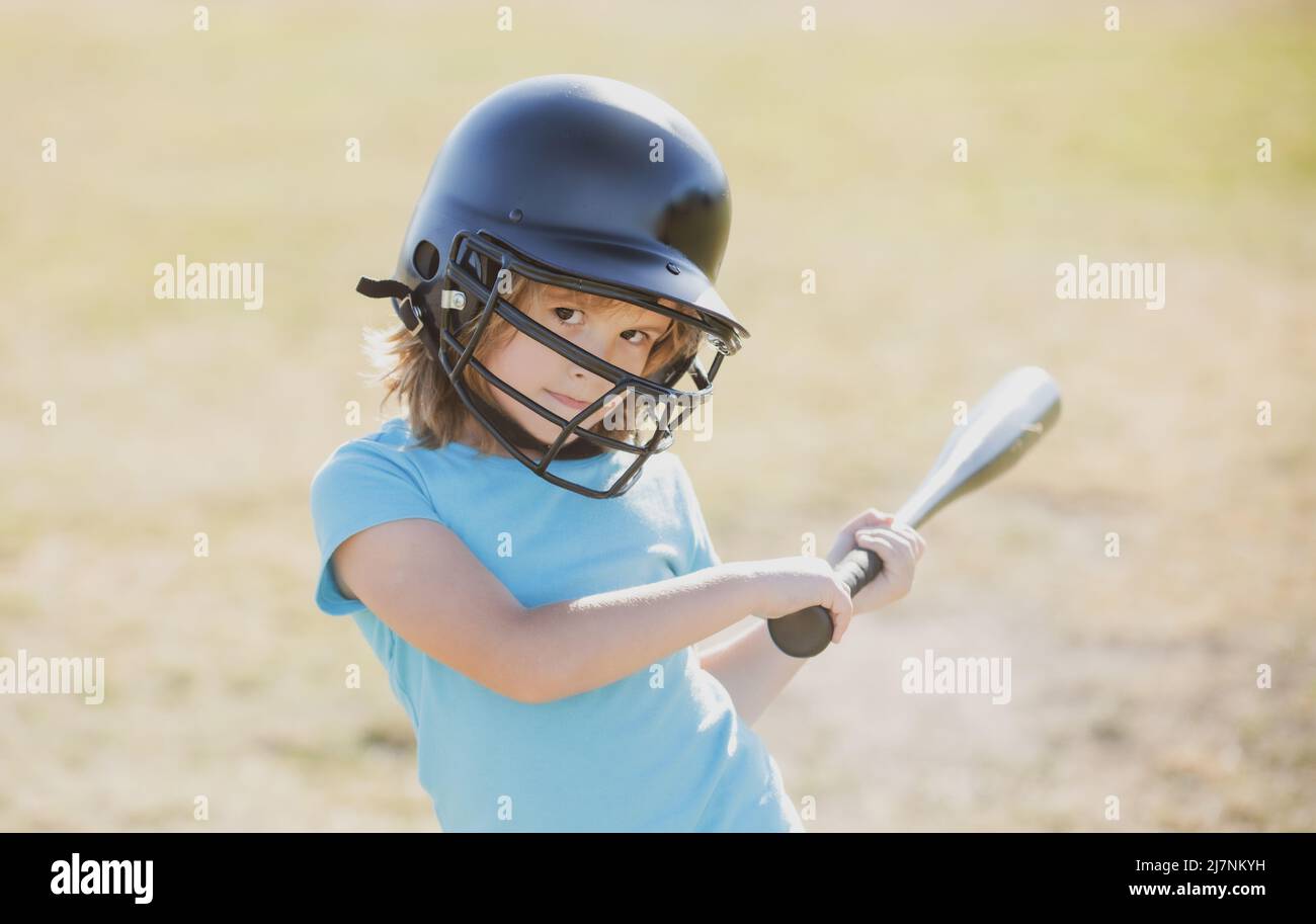 Portrait of kid in baseball helmet and baseball bat ready to bat Stock ...
