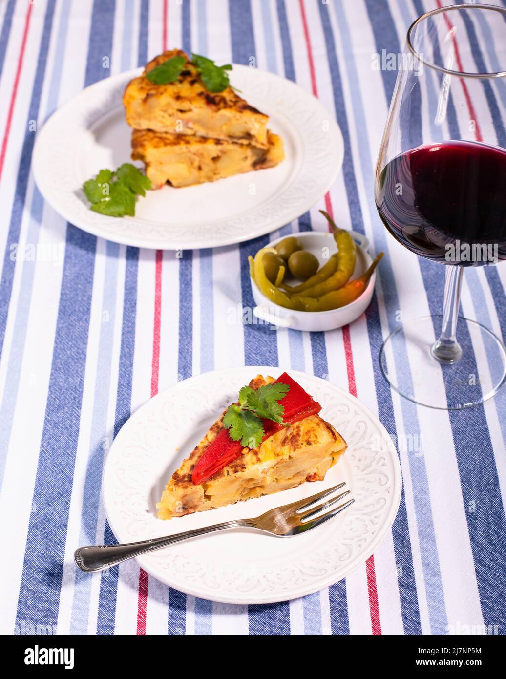 Traditional Spanish starter tortilla patatas served with red piquillo ...