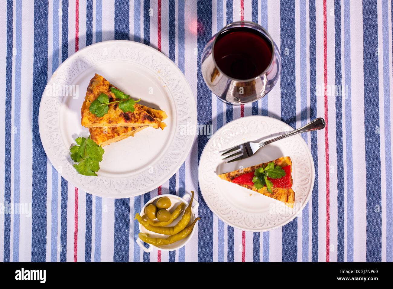 Traditional Spanish starter tortilla patatas served with red piquillo ...