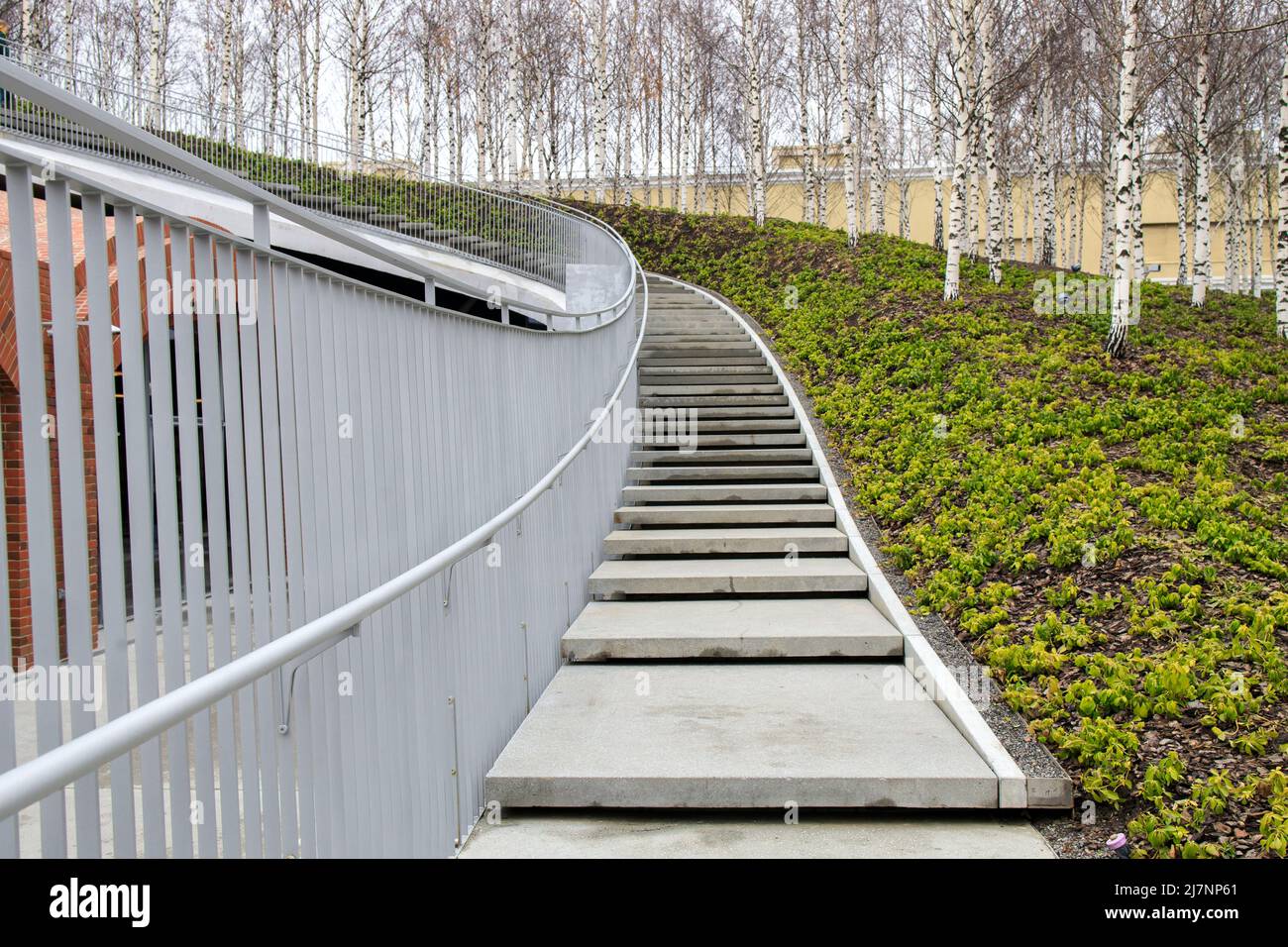 Tall modern winding staircase with railings in a birch grove. GES-2 ...