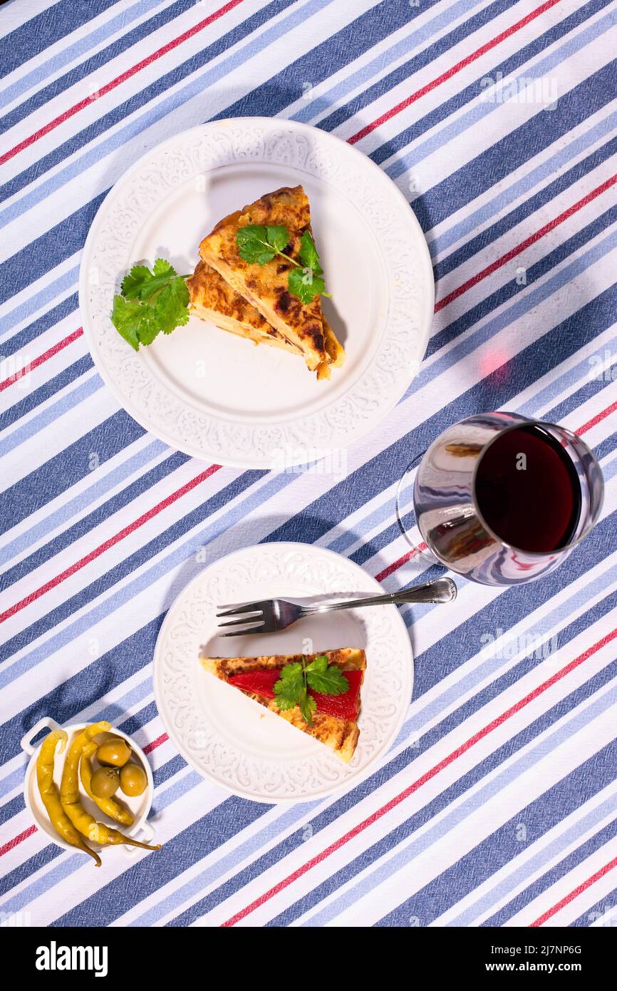 Traditional Spanish starter tortilla patatas served with red piquillo ...