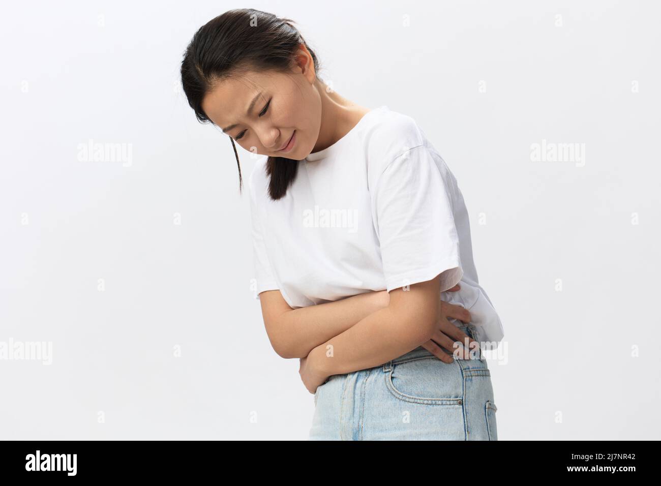 Stomach ulcer Gastritis. Tormented suffering tanned beautiful young ...