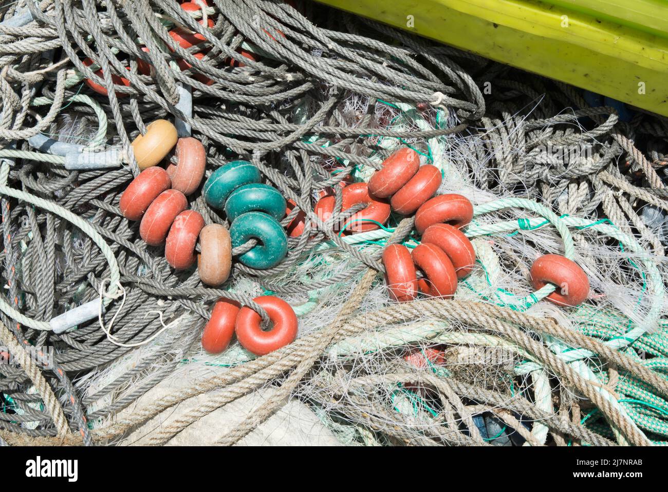 Used fishing net with colorful pvc floats out of water for repair ...