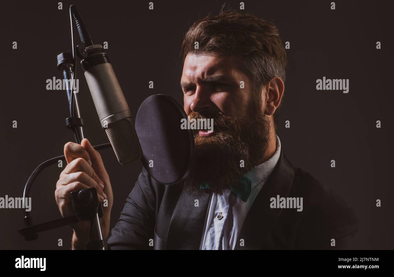 Classic singer. Sound producer recording song in a music studio ...