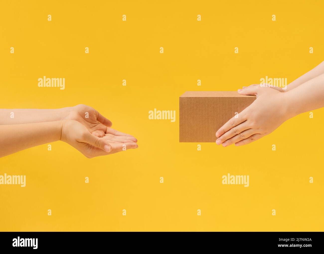 Hands handing over a parcel in a cardboard box Stock Photo - Alamy