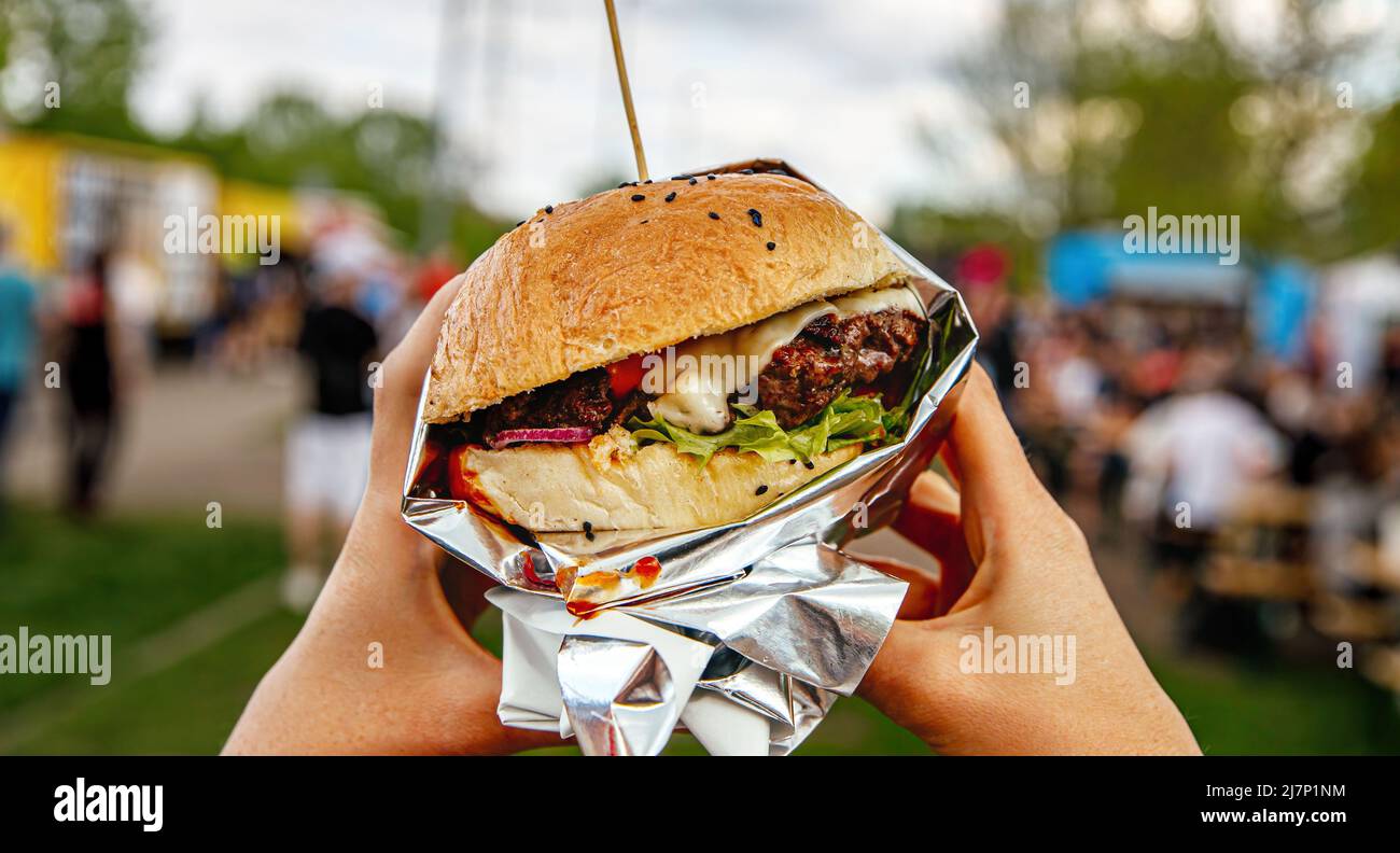 Hamburger at outdoor street food market festival in a park Stock Photo ...