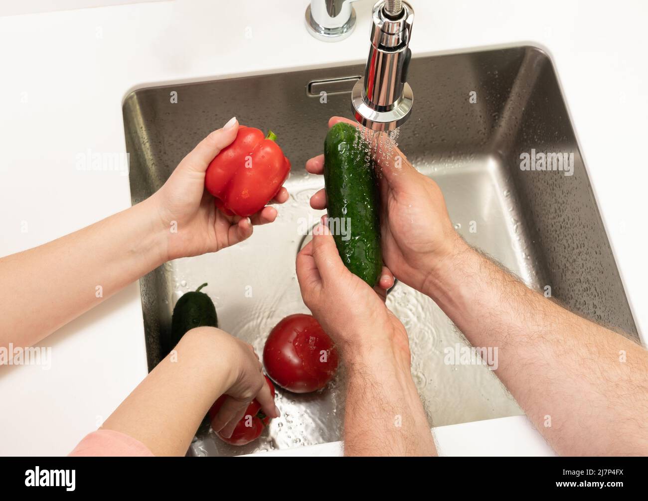 woman washing vegetables in the kitchen over the sink Stock Photo - Alamy