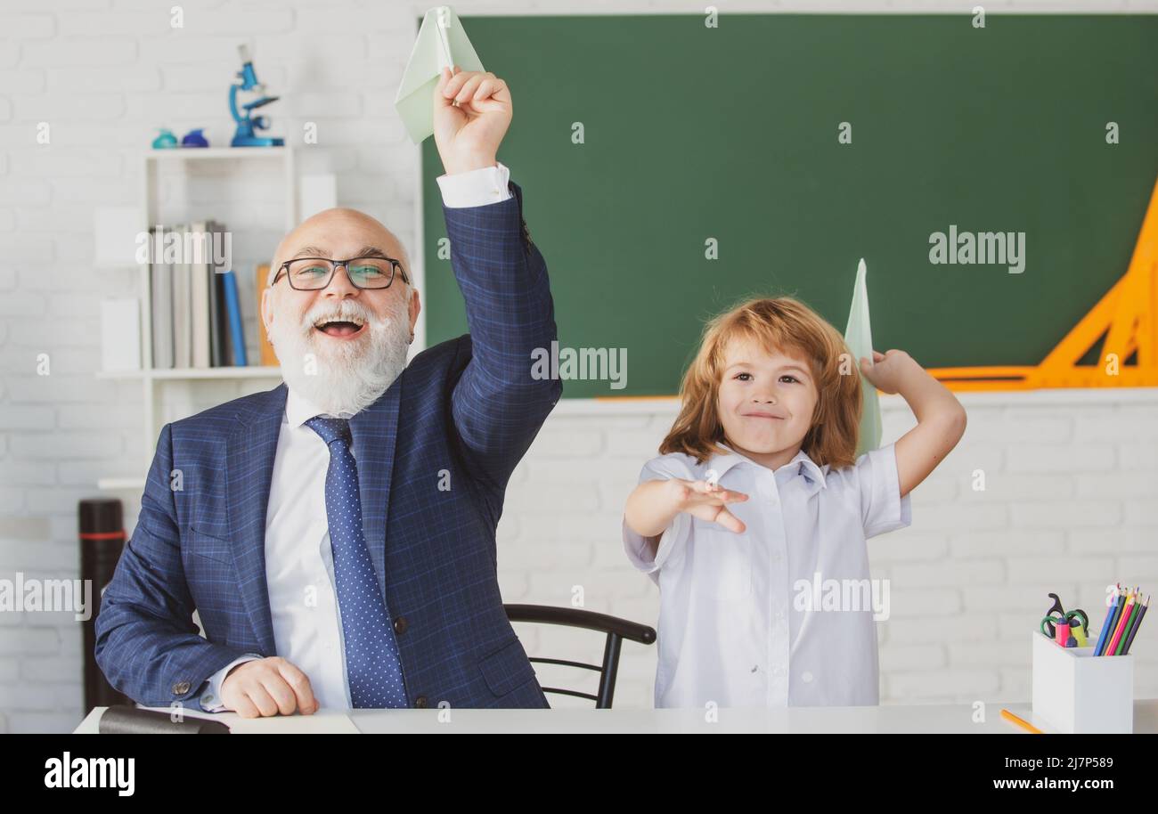 Grandfather helping to grandson with school assignment. Developing ...