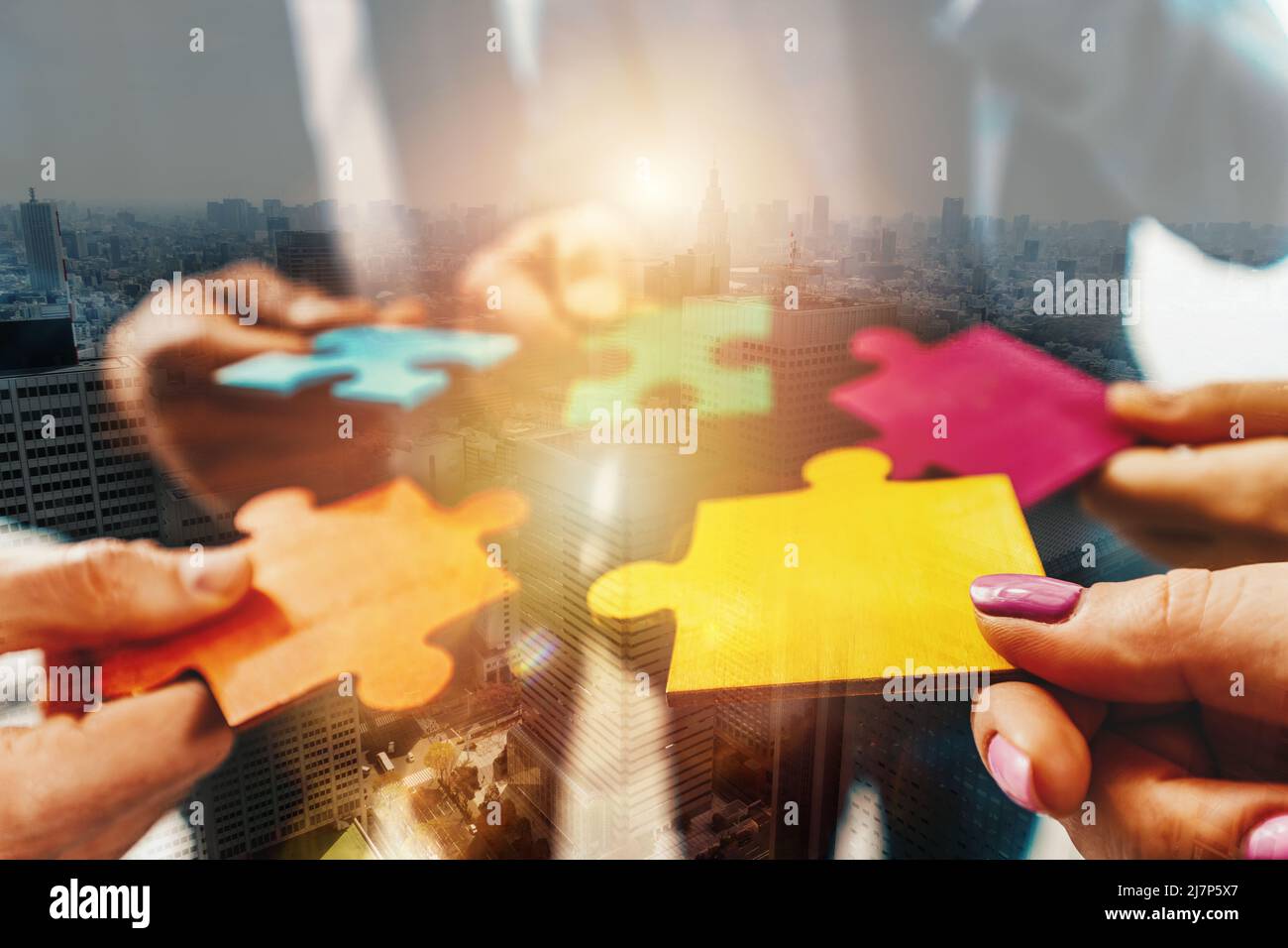 Teamwork of partners connect puzzle pieces as integration and startup ...