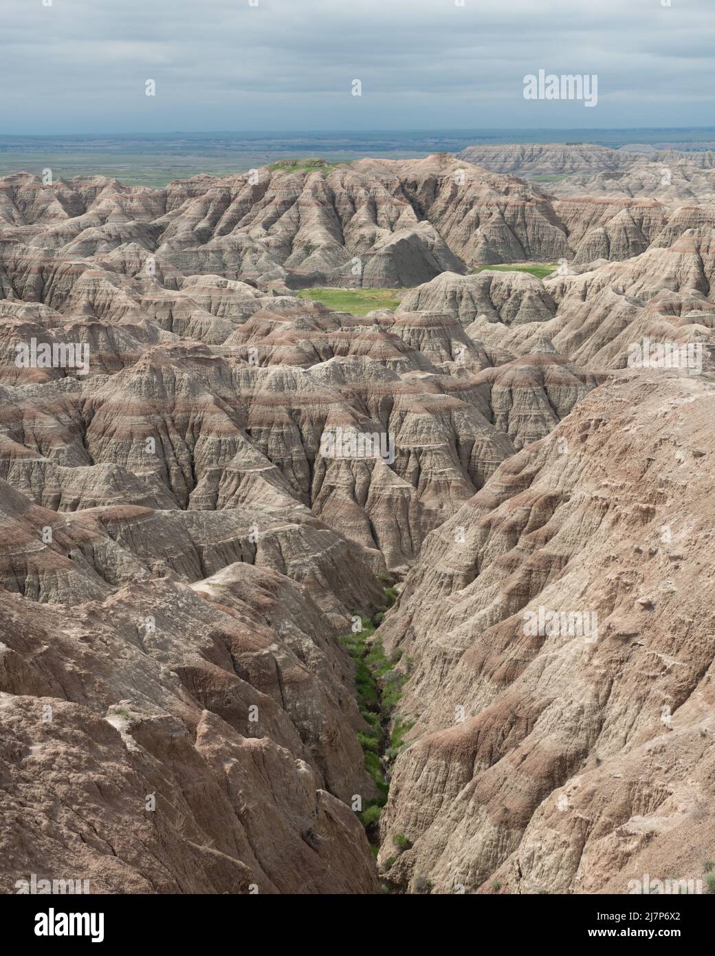 Sunlight Paints the layered hills of Badlands National Park Stock Photo ...