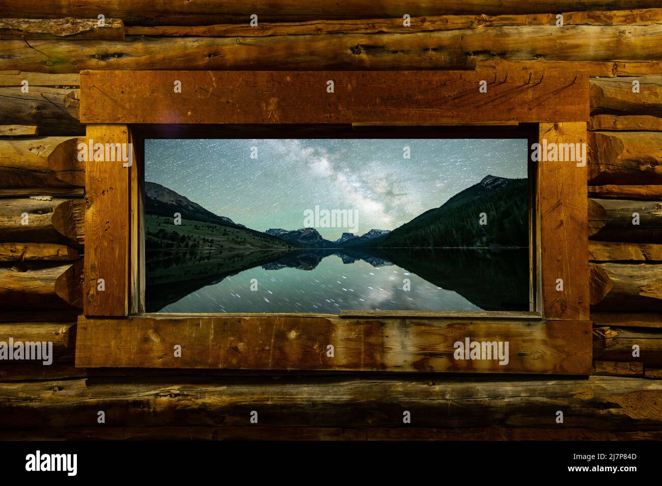A log cabin and the beautiful mountains of the Wind River Range Stock ...