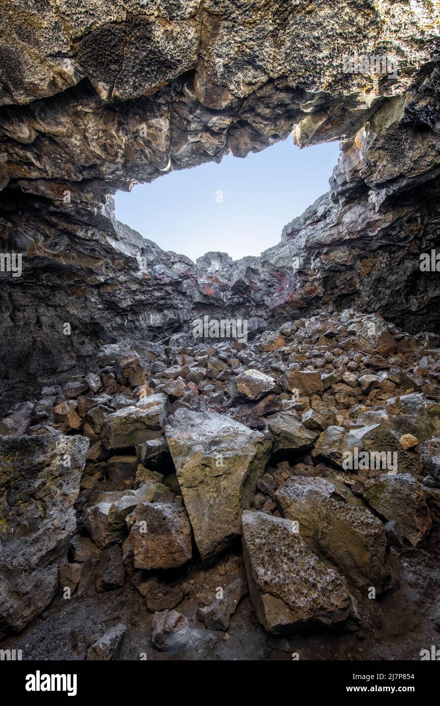 A collapse in the roof of a lava tube snaking underneath the sur Stock ...