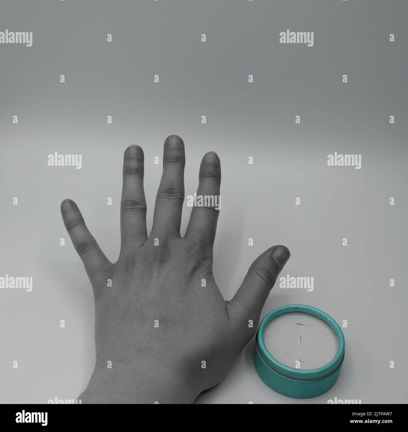 black and white filter on hand with fingers spread, and the only color ...