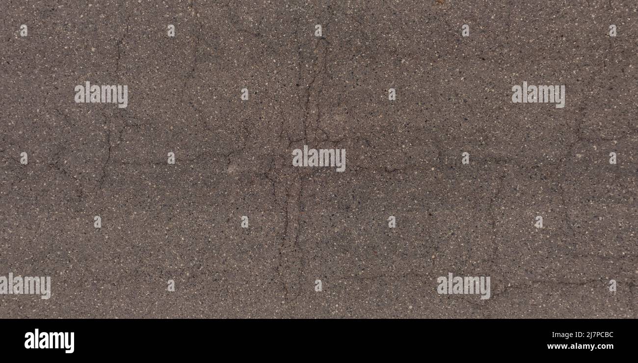 view from above on surface texture of old asphalt road with cracks ...