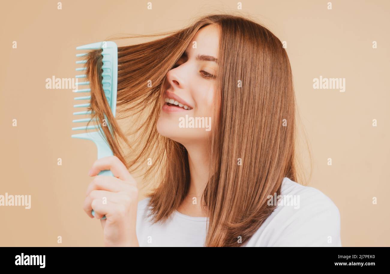 Beautiful woman combs her healthy hair. Combing healthy long straight ...
